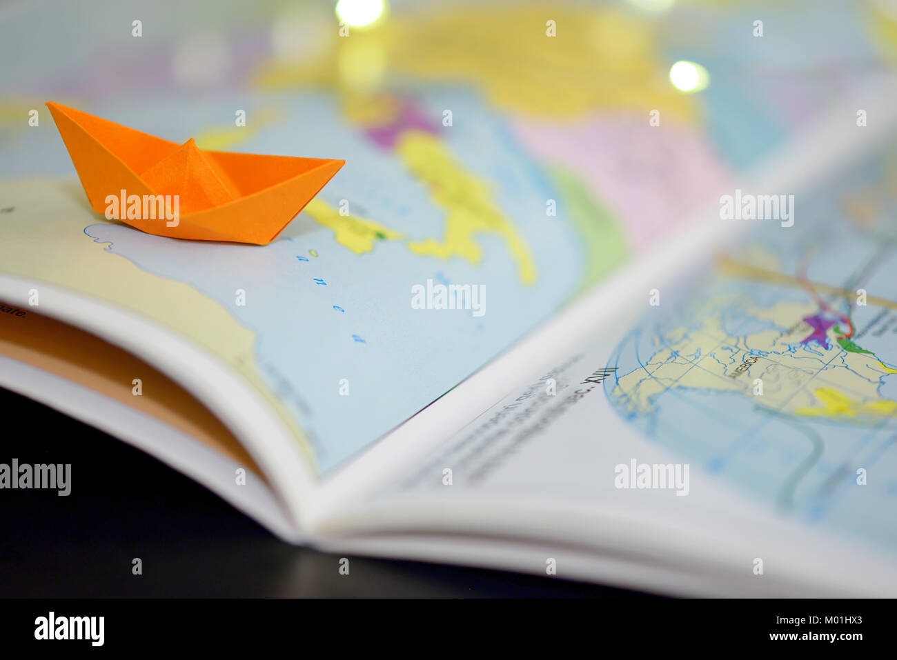 Paper boat on a atlas book map of the world Stock Photo - Alamy