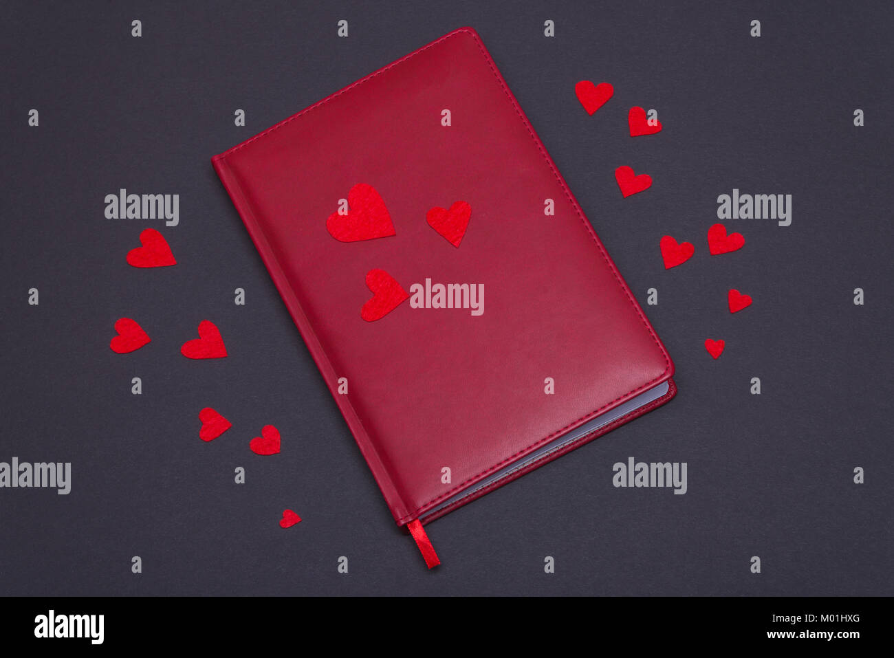 Diary with red hearts on a dark background Stock Photo - Alamy