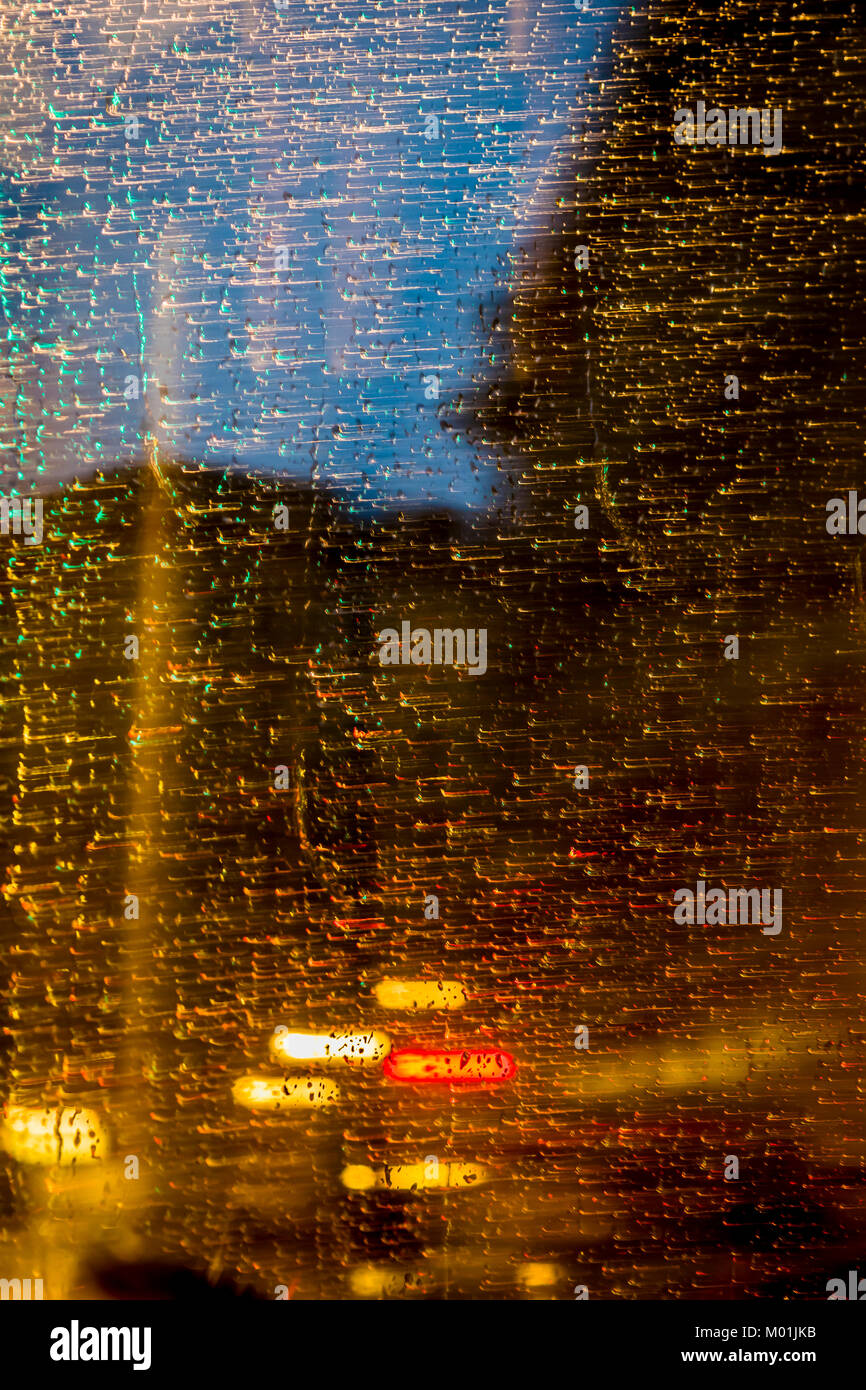 Raindrops on train window. Raindrops run down on train window, evening ...
