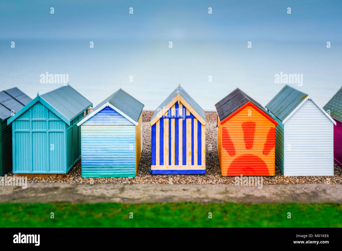 pretty painted colourful wooden beach huts with a tilt shift effect on ...