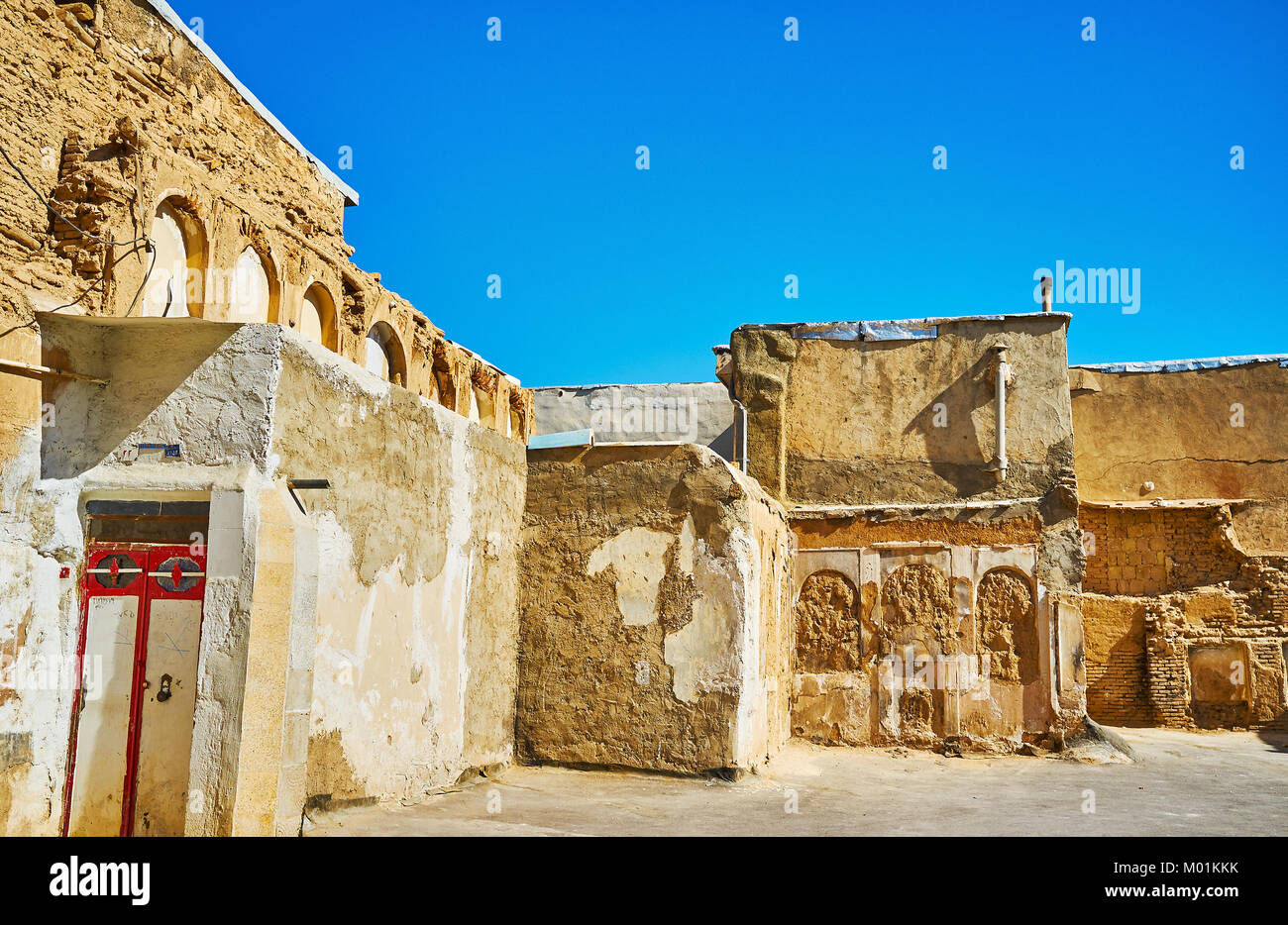The row of old buildings with shabby walls and crumbled plaster in ...