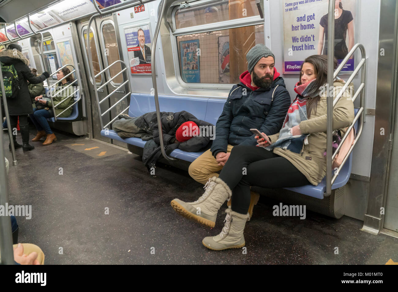 Homeless man takes up several seats as he sleeps in a subway car in New ...