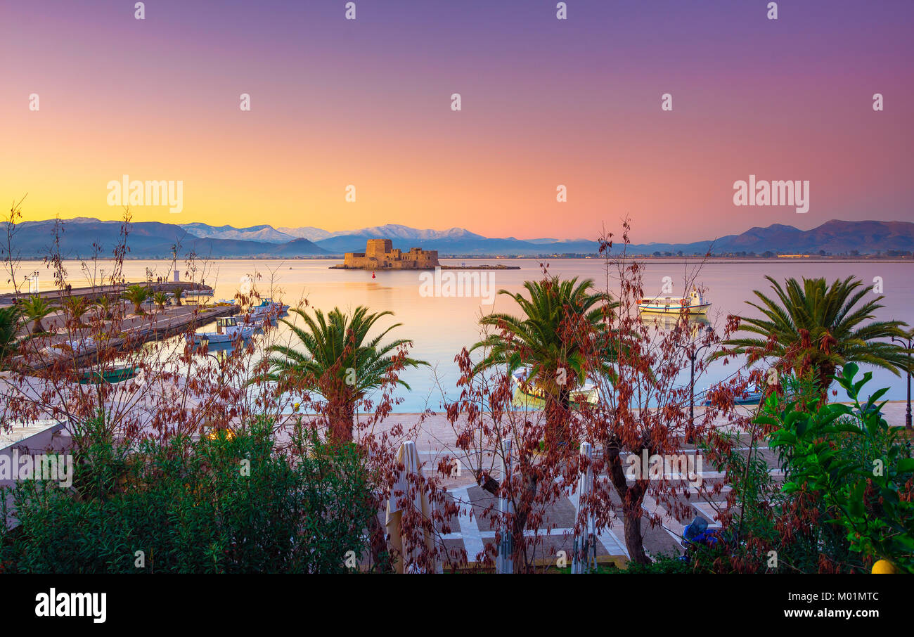 Beautiful port of Nafplio city in Greece with small boats, palm trees ...