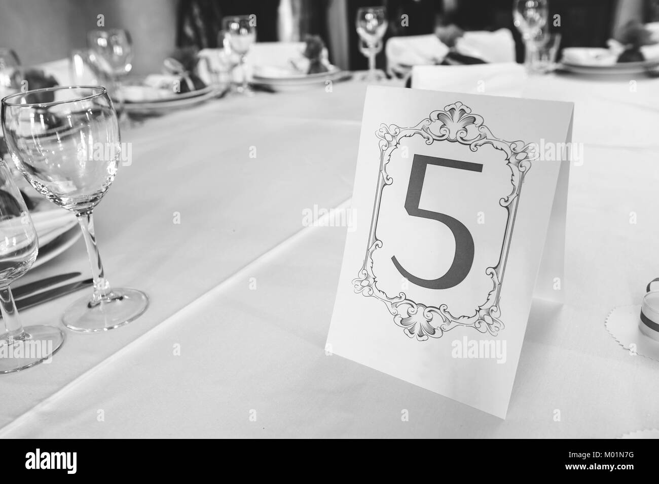 Wedding table with the sign number five, pictures in BW Stock Photo - Alamy