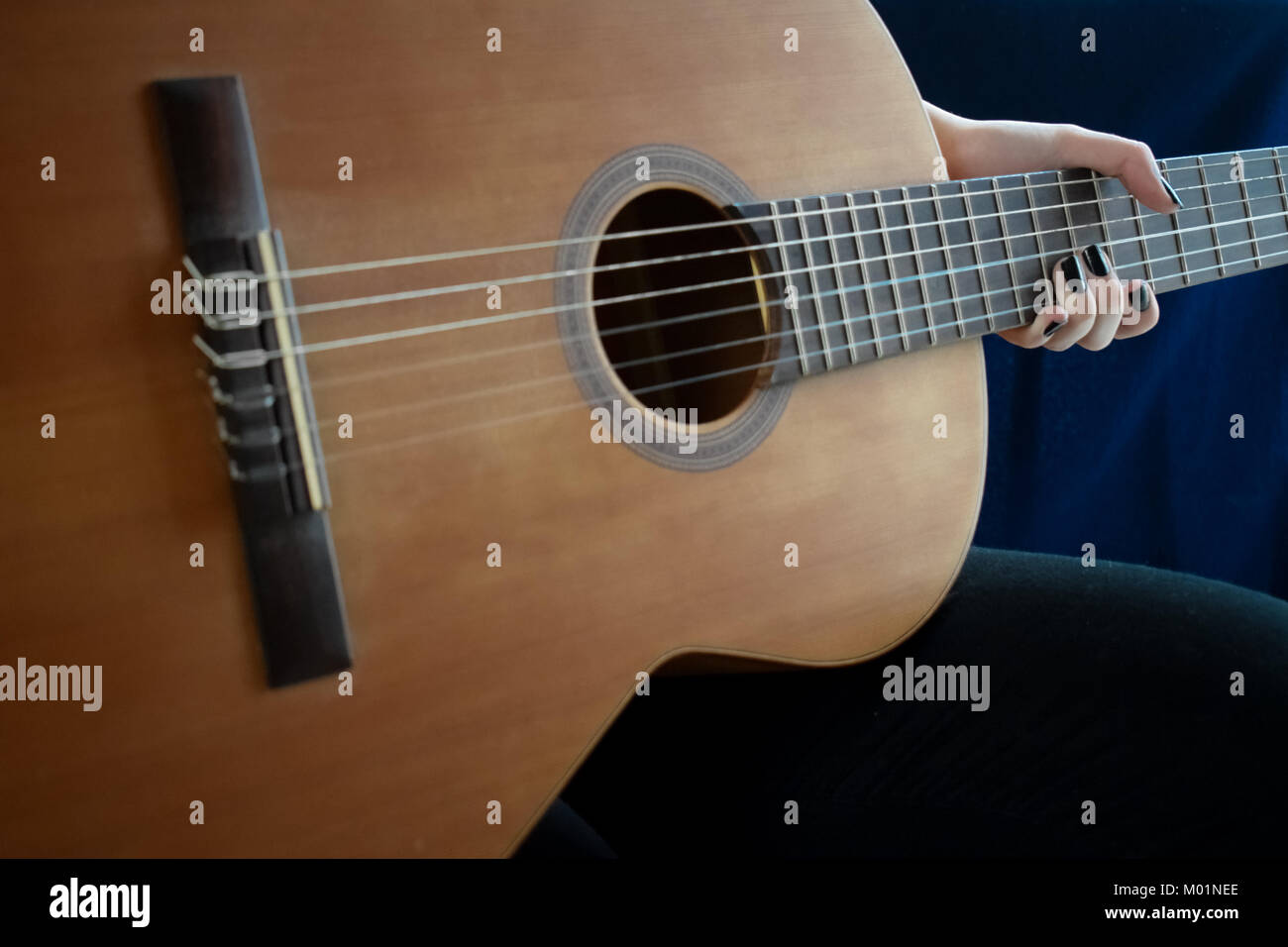 Female playing acoustic guitar Stock Photo - Alamy