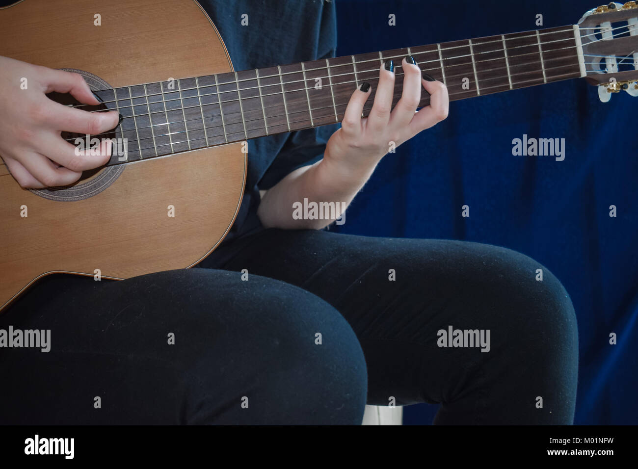 Female playing acoustic guitar Stock Photo - Alamy