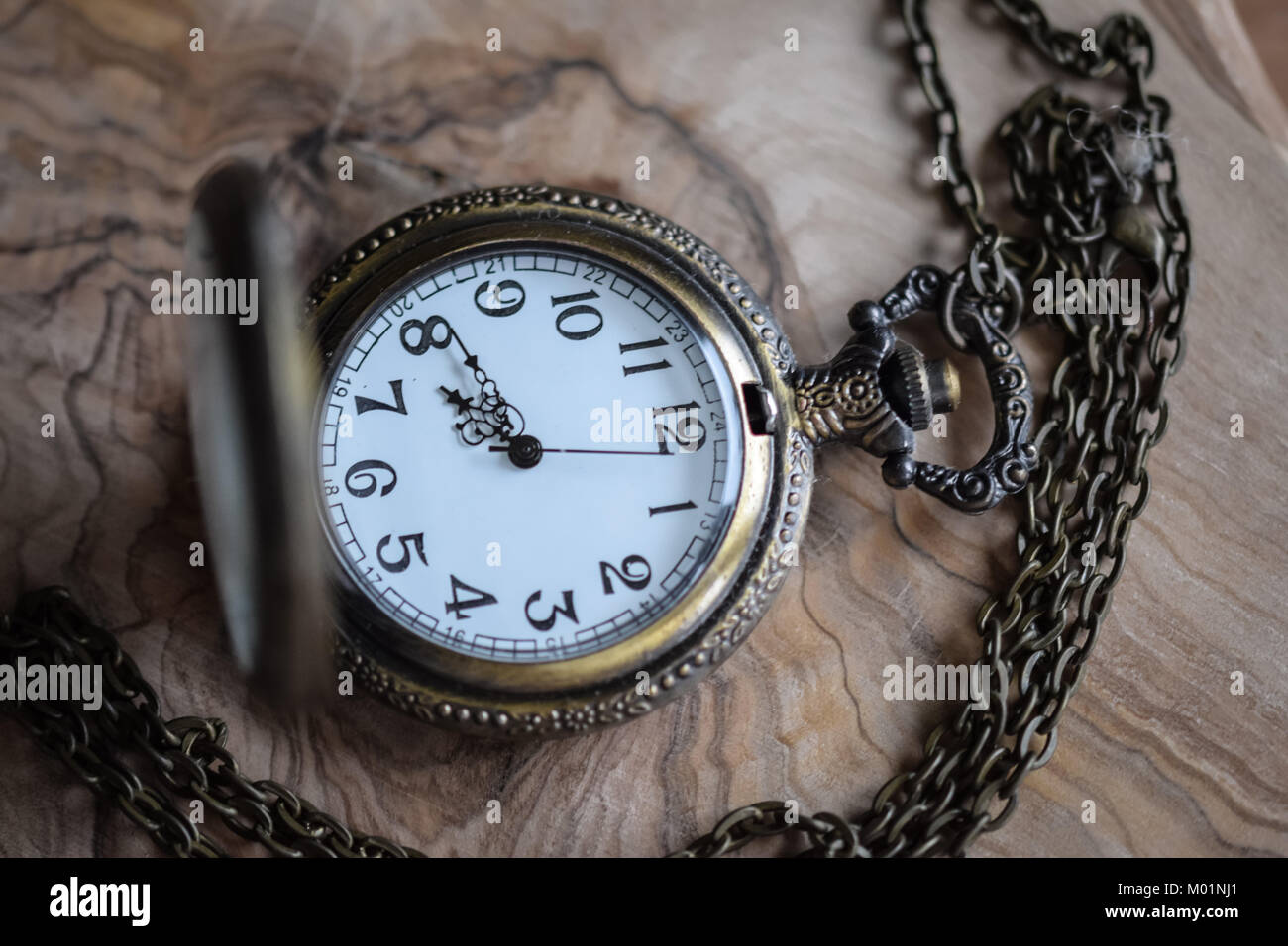 Vintage pocket watch with wooden background Stock Photo - Alamy