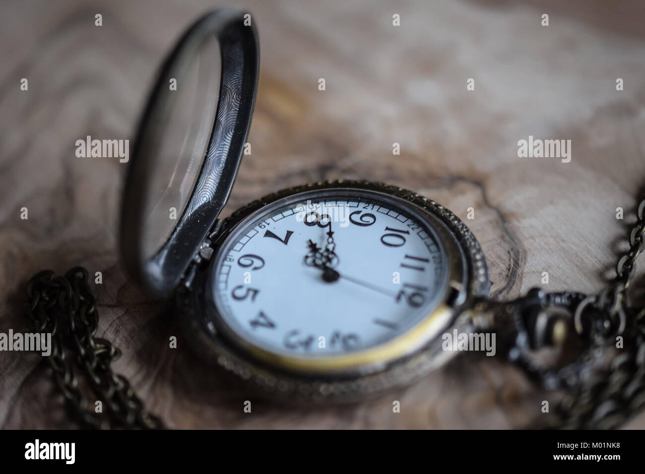 Vintage pocket watch with wooden background Stock Photo - Alamy