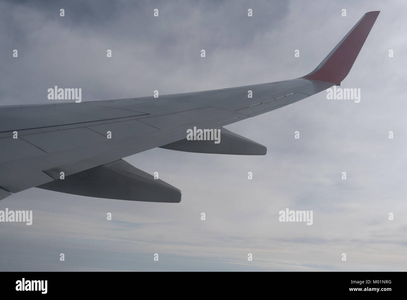 Airplane wing with sunrise in light flare Stock Photo - Alamy