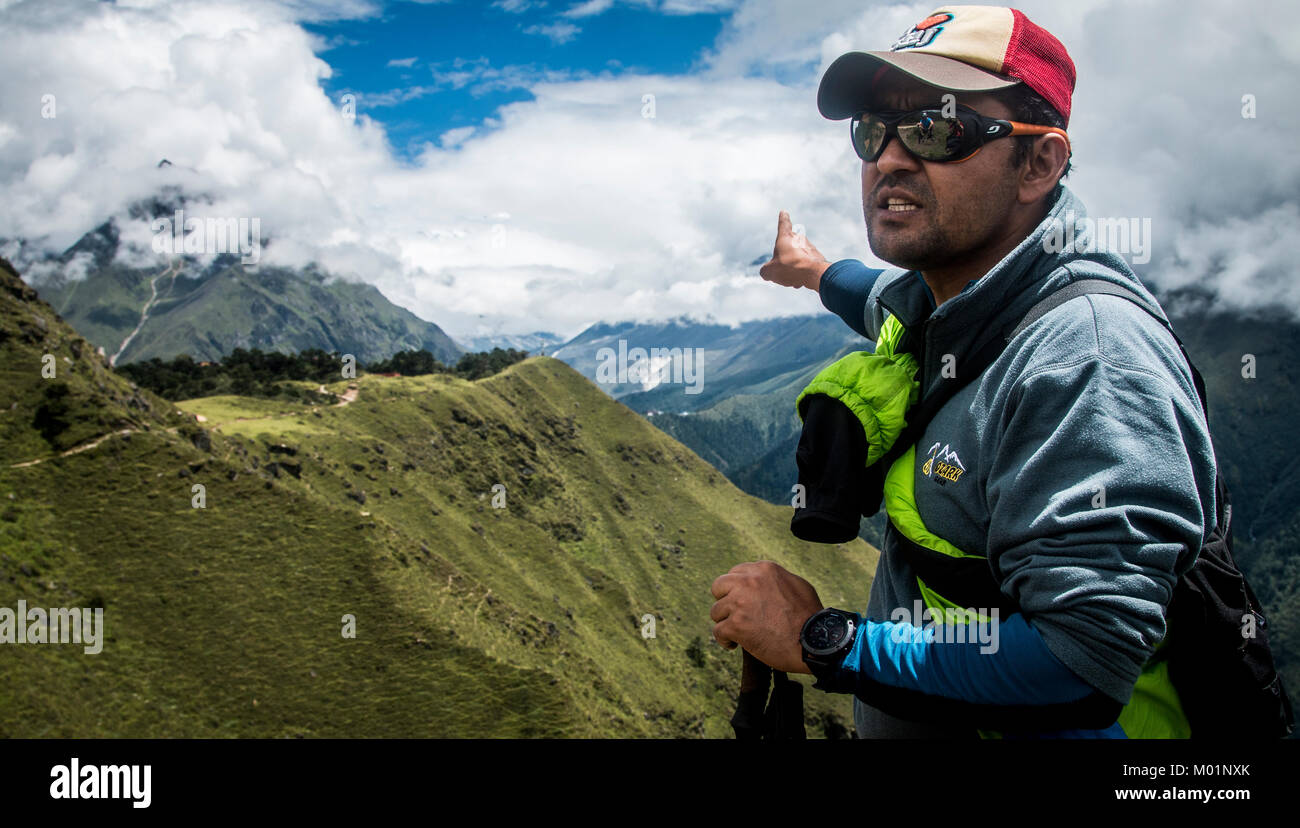 Everest Base Camp Guide Pointing Towards Mountains Stock Photo - Alamy