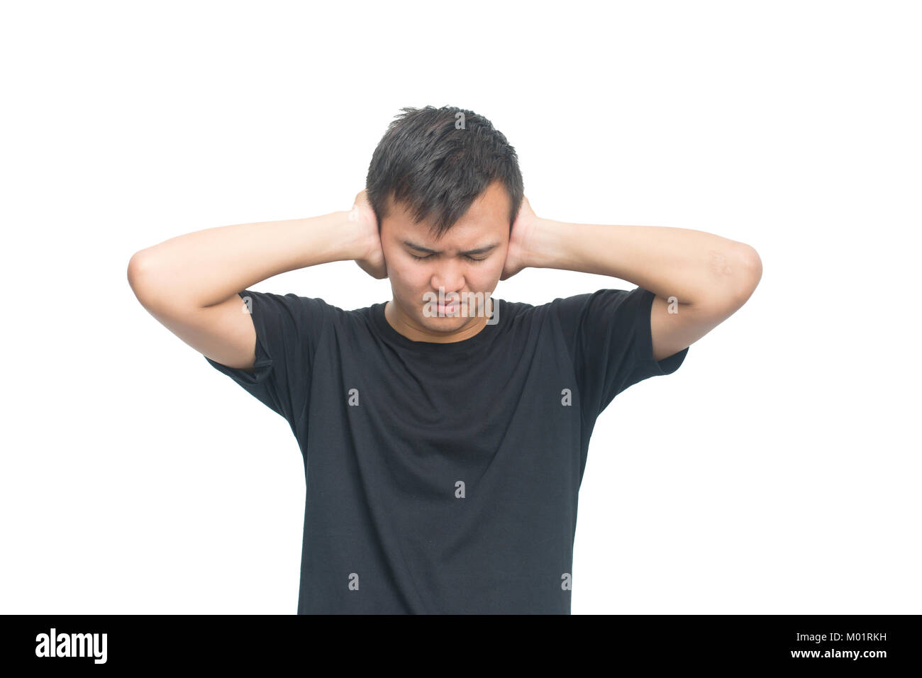 The man, loudly, closed her ears with his hands isolated on white ...