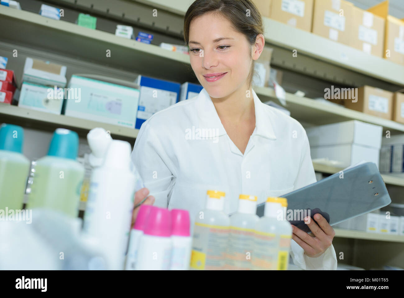 smiling female pharmacist at work Stock Photo - Alamy