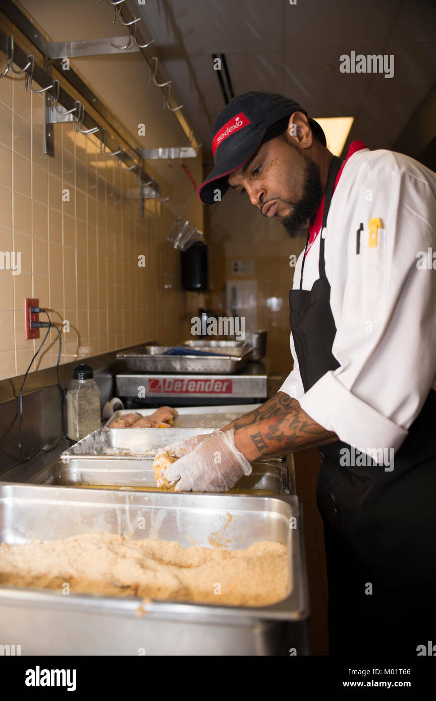 A civilian food services employee prepares food during The Officer ...
