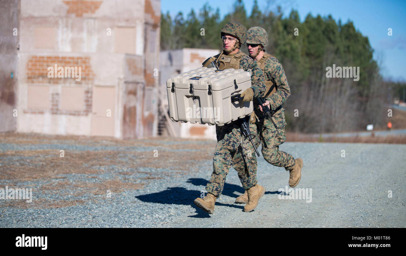 U.S. Marines carry cargo during the presentation of the Office of Naval ...