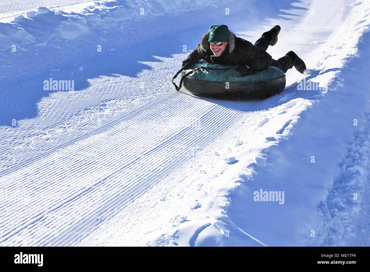 A snow-tuber slides down a snow-tubing lane at Whitetail Ridge Ski Area ...