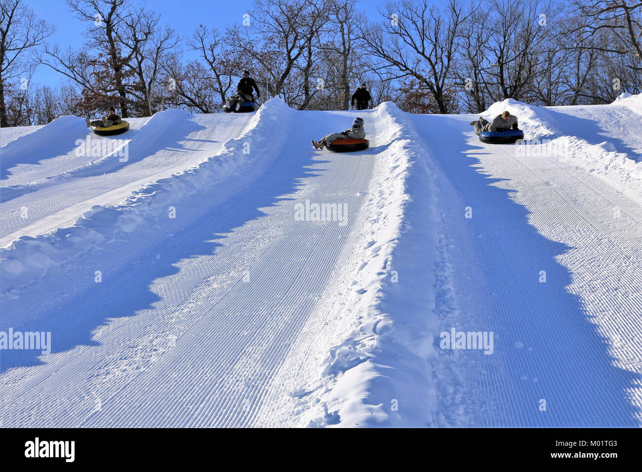 Snow-tubers slide down snow-tubing lanes at Whitetail Ridge Ski Area on ...