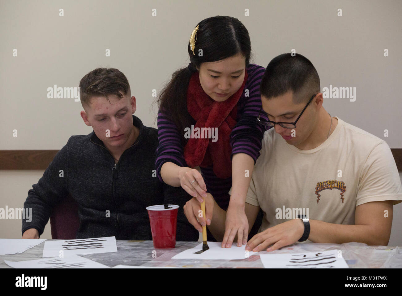 CAMP HANSEN, OKINAWA, Japan – Kumiko Tamashiko, middle, teaches Pfc ...