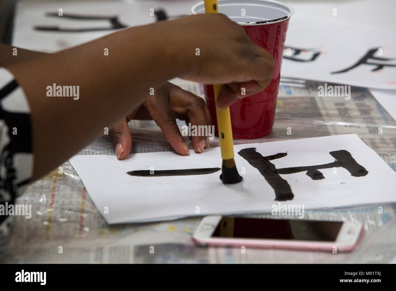 CAMP HANSEN, OKINAWA, Japan –A student practices writing Happy New Year ...