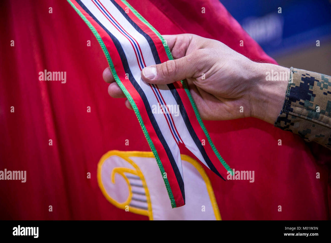 A U.S. Marine with 11th Marine Regiment rededicates the regimental ...