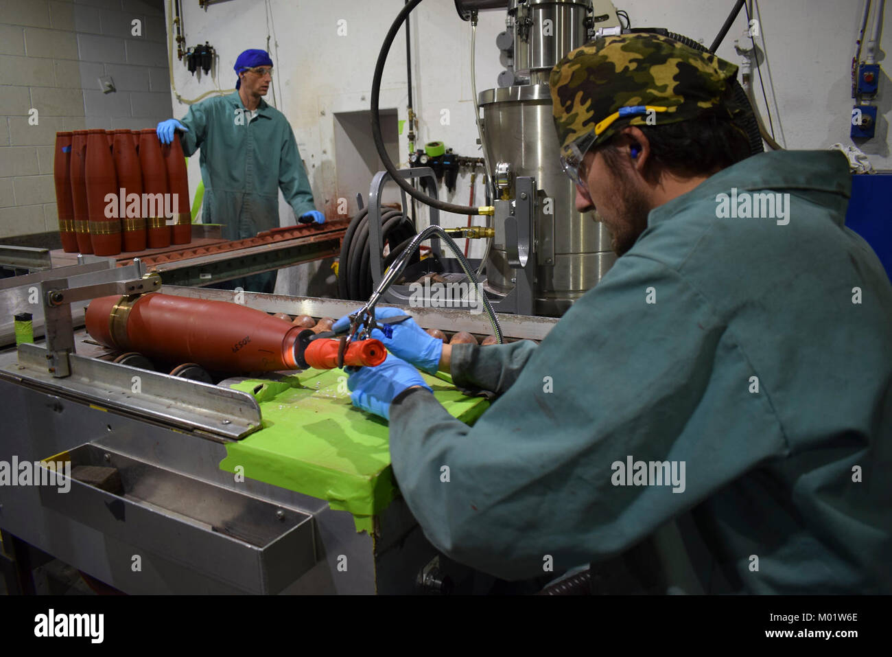 Crane Army employees manufacture rounds for the MK 45 five-inch gun ...