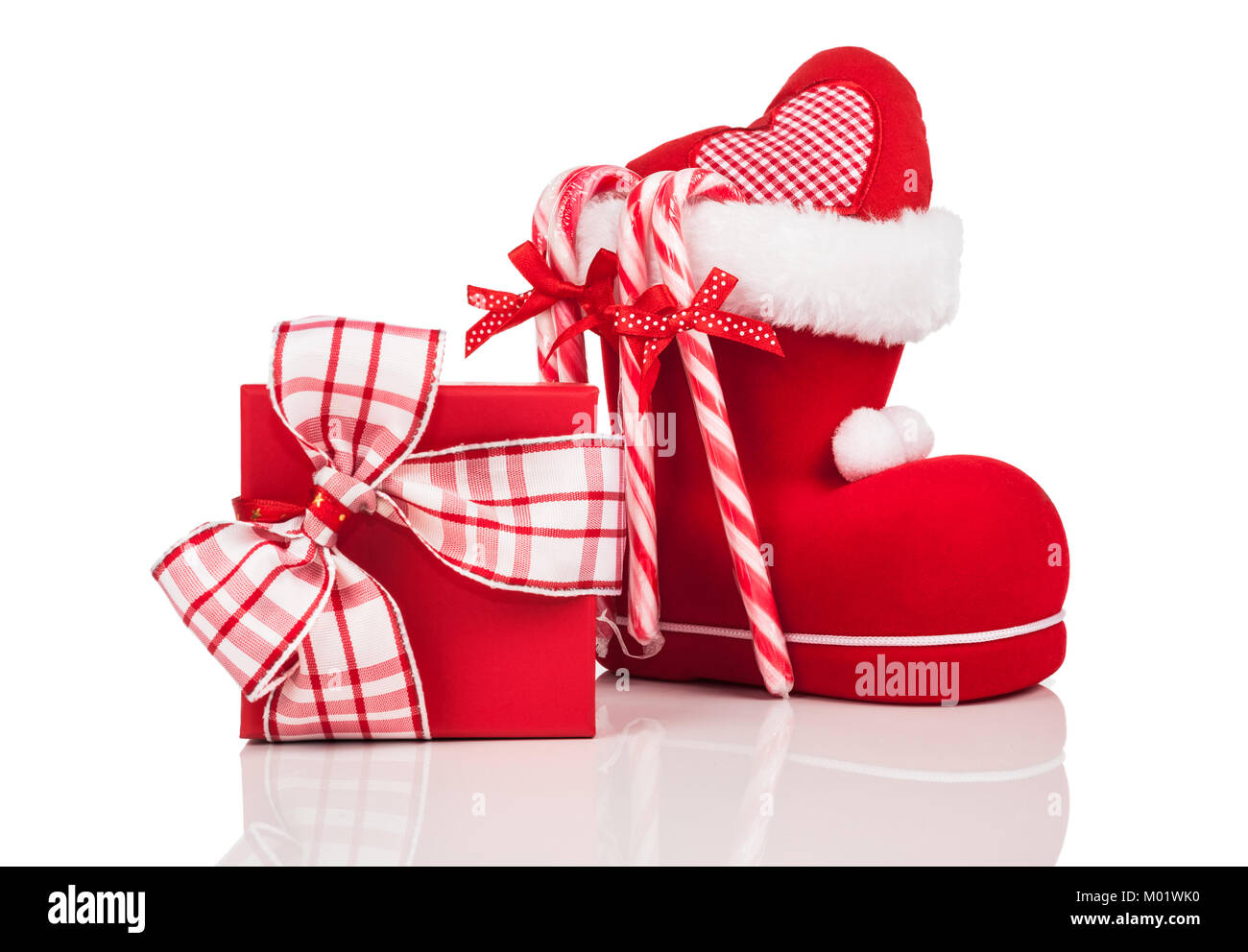 Santa's Boot, candy sticks and red Christmas gift box on white ...