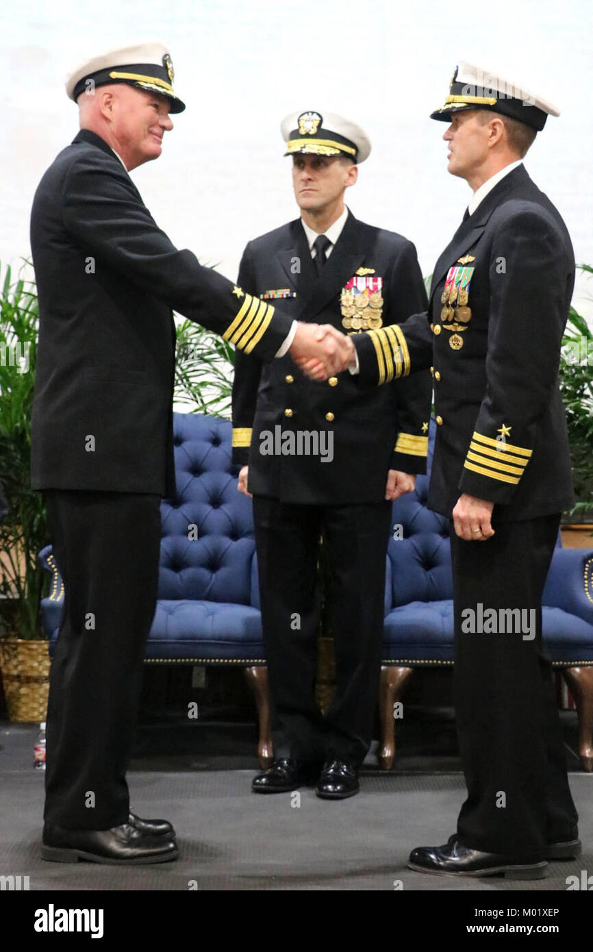 U.S. Navy Capt. Ron Piret (right) relieves Capt. Greg Ireton (left) as ...