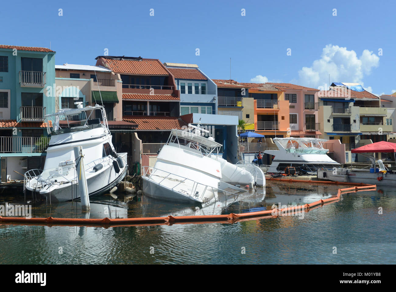 Members of the Hurricane Maria ESF-10 response work to dewater vessels ...
