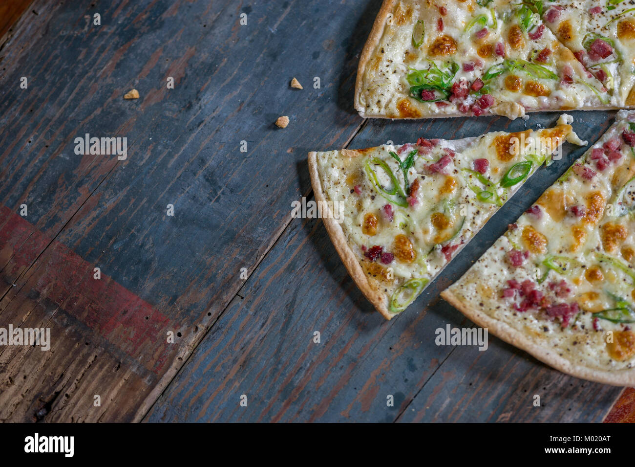 Tarte Flambee on a wood table Stock Photo - Alamy
