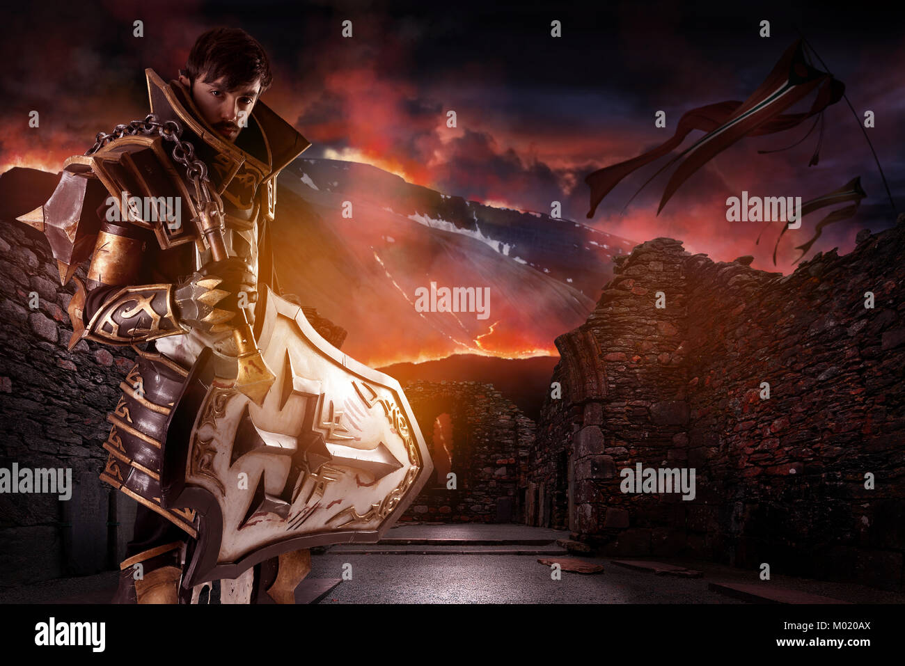 Young man cosplaying with fantasy knight costume over a fantasy ...