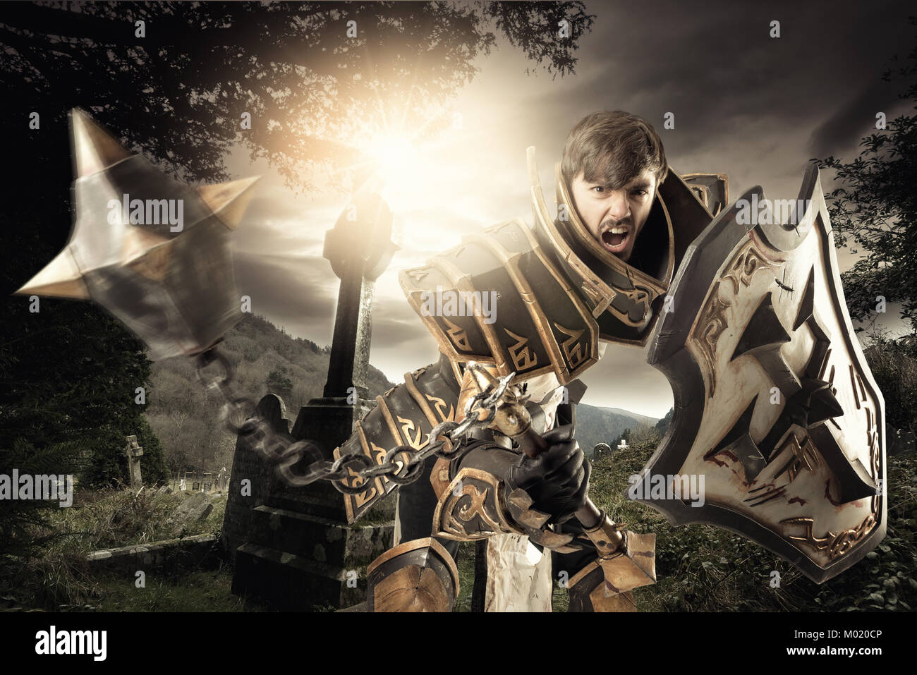 Young man cosplaying with fantasy knight costume Stock Photo - Alamy