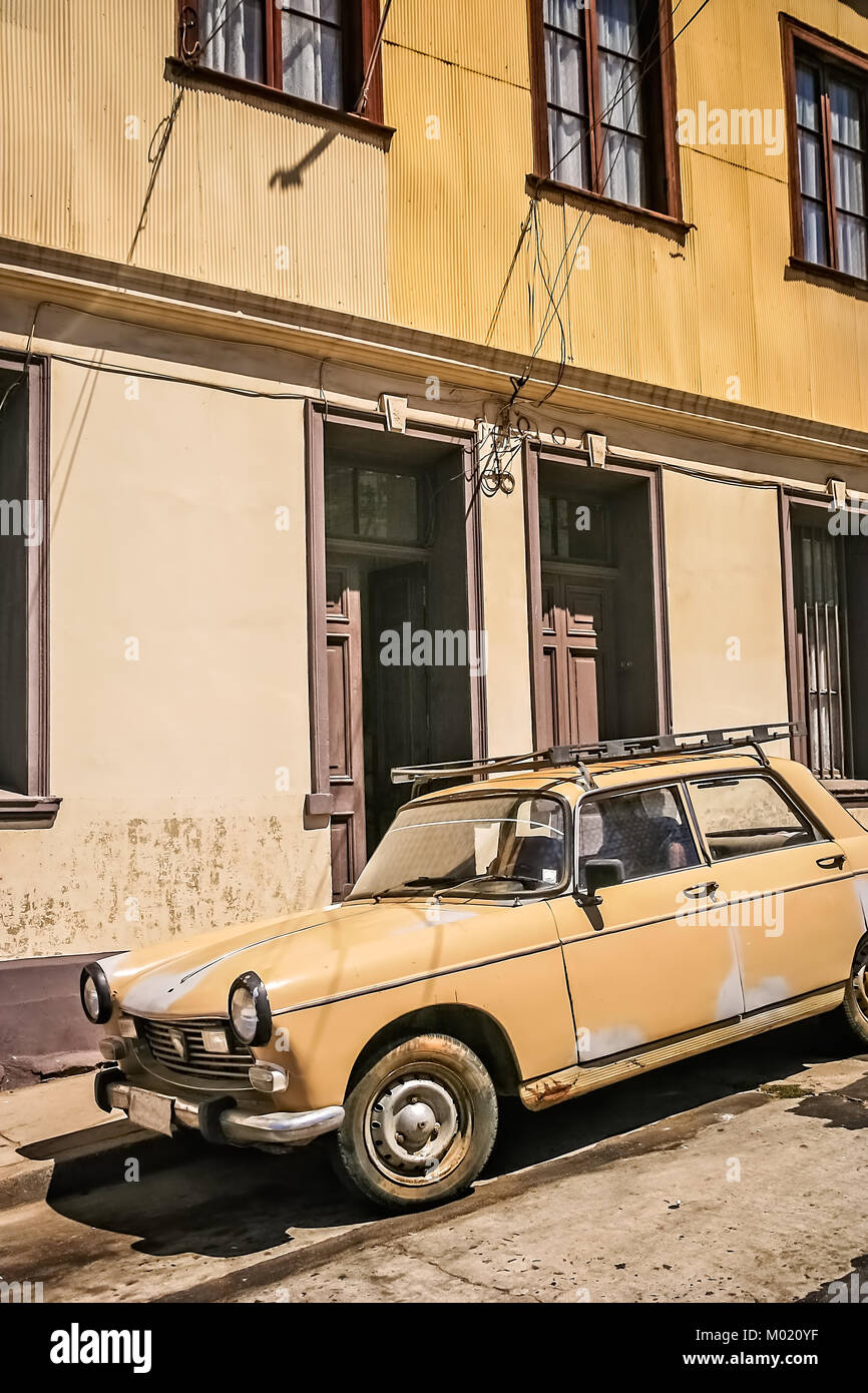 Old retro vintage car in front of the old tenement house on the steep ...
