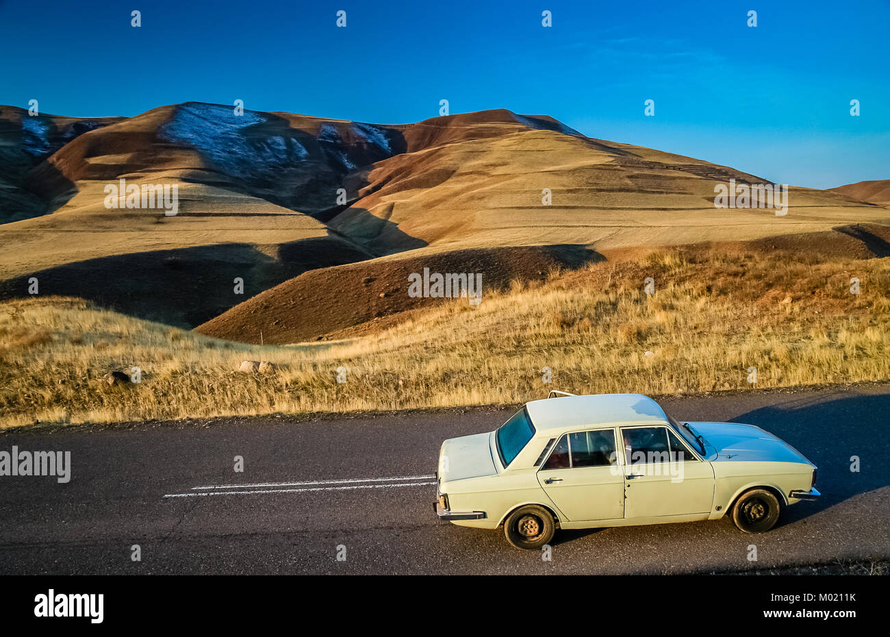 White paykan car stopping en routh through the pass in the beautiful ...