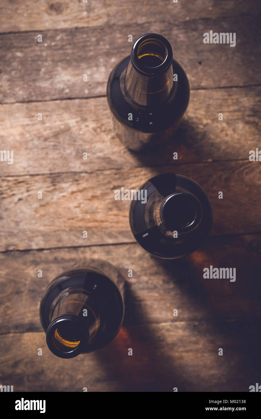 Beer bottles on an old wooden table. Top view Stock Photo - Alamy
