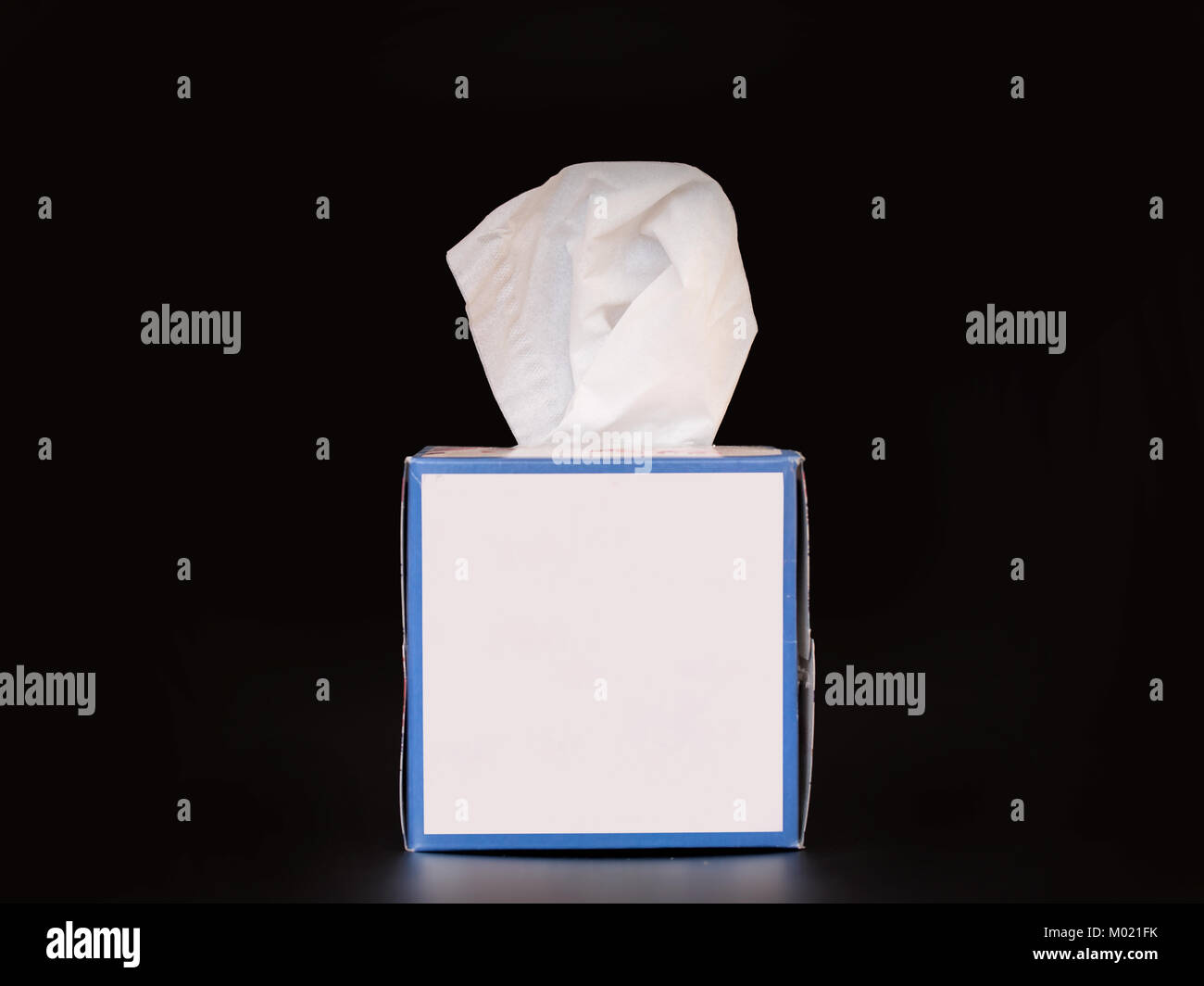Tissue box on black background Stock Photo - Alamy