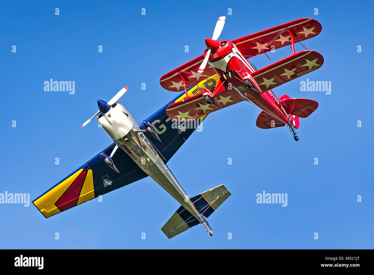 Two colourful competition aircraft taking-off together at the 2013 ...