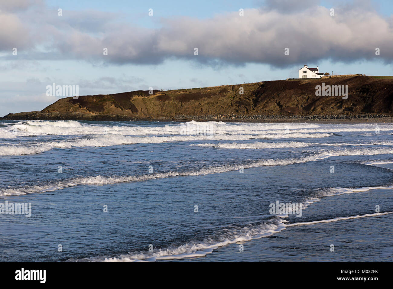 View of a white house on the cliffs at the end of Sandy Beach, Porth ...