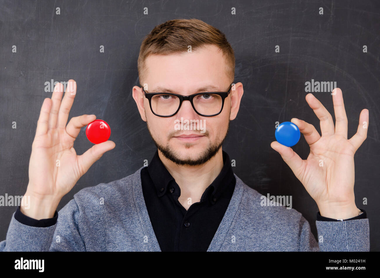 a man with glasses offers to choose one of the options - choosing a red ...