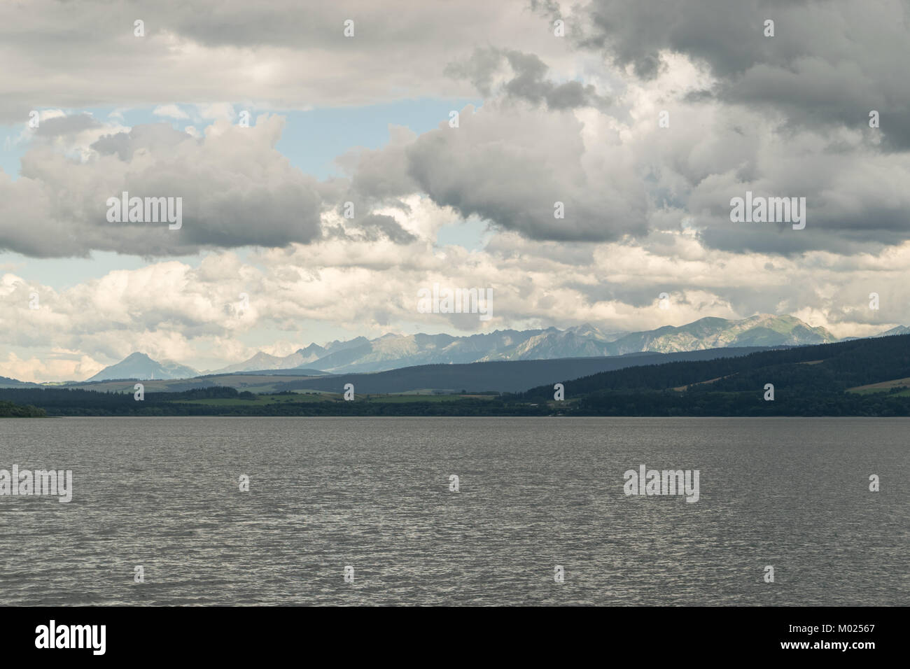Orava reservoir with mountains in the background Stock Photo - Alamy
