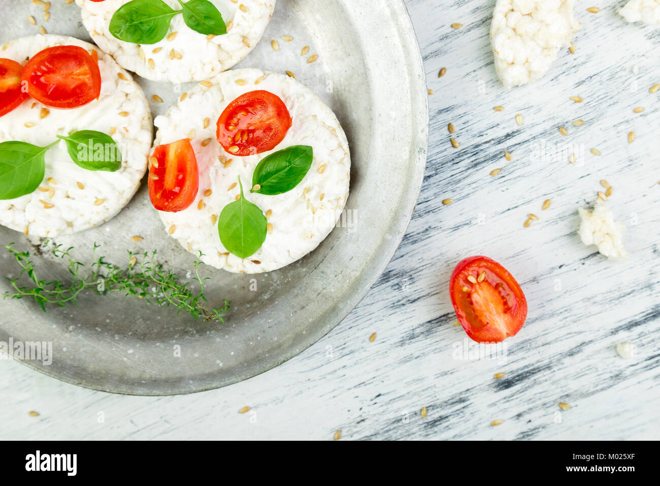 Healthy Rice Cakes with cherry tomatoes, cheese feta, basil and sesame ...