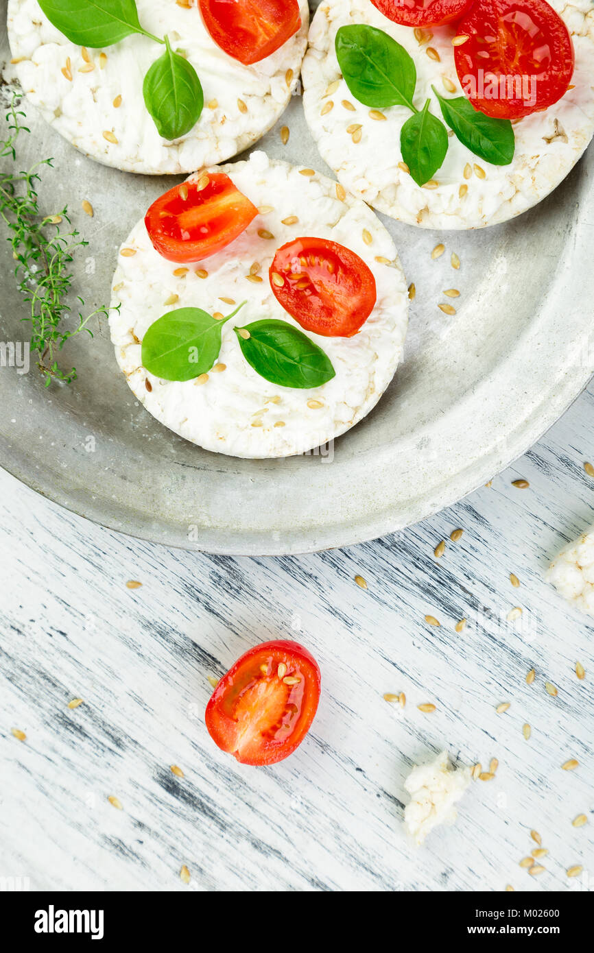 Healthy Rice Cakes with cherry tomatoes, cheese feta, basil and sesame ...