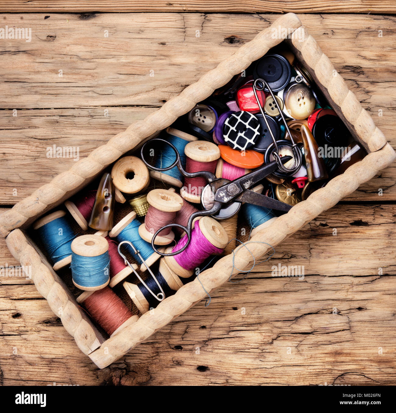 Wooden retro box, with thread spools and buttons. Sewing accessories ...