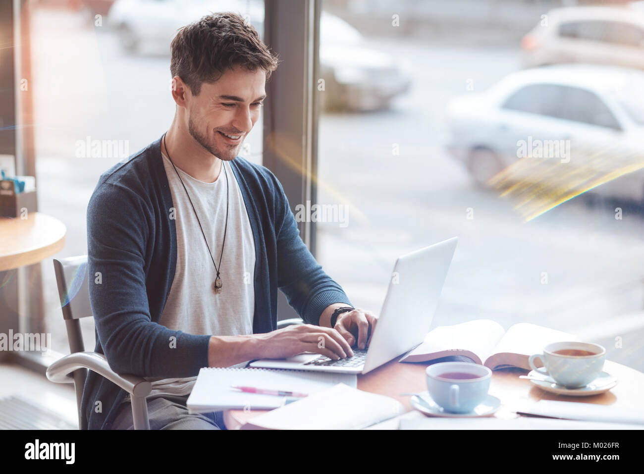 Handsome bearded man looking at screen of his laptop Stock Photo - Alamy