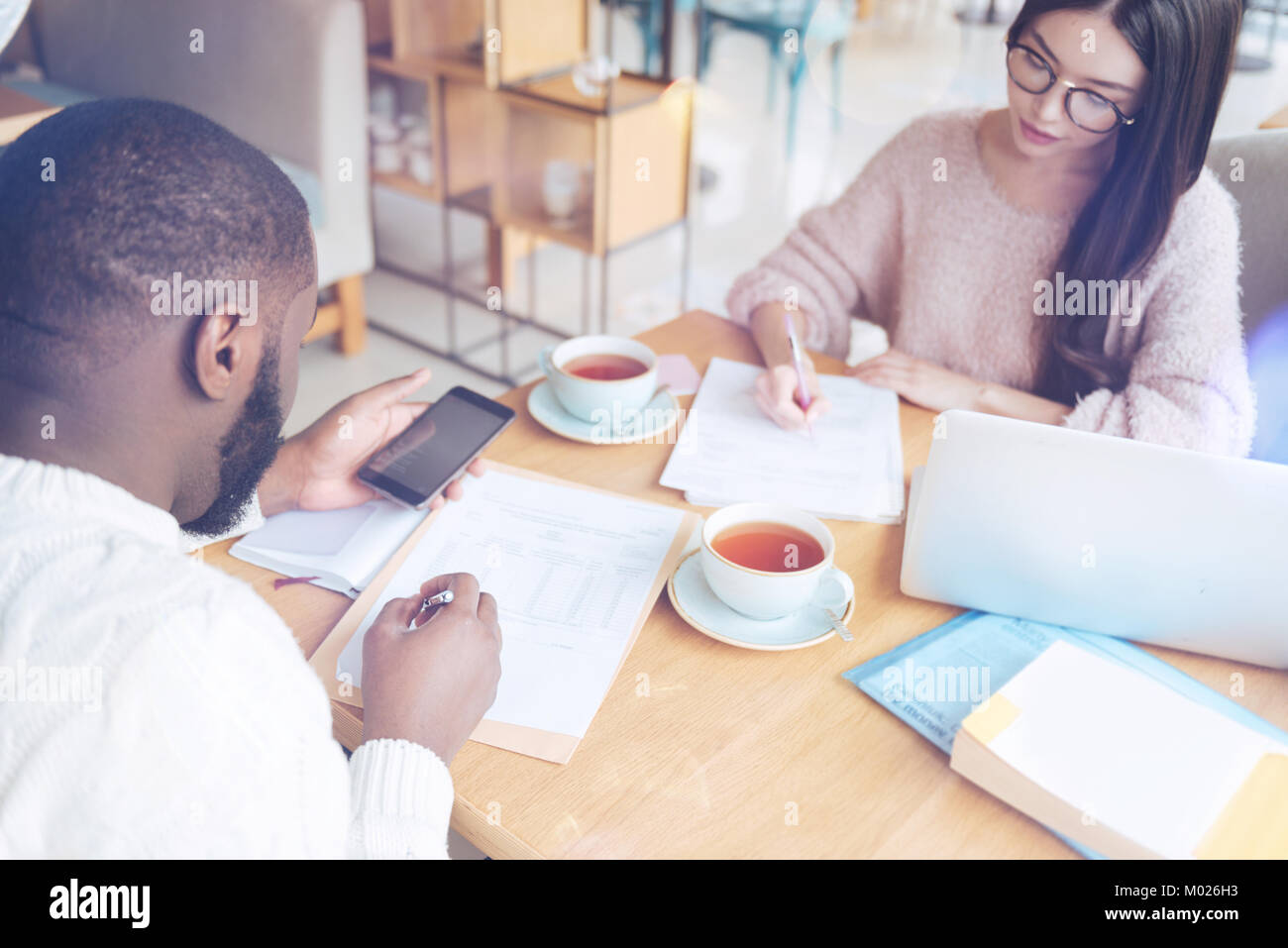Concentrated male person completing a form Stock Photo - Alamy