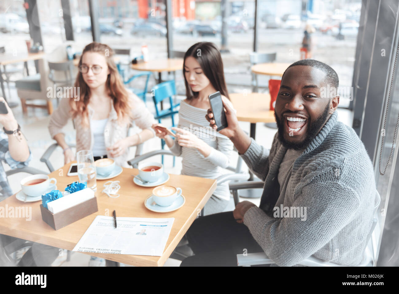 Happy black man expressing positivity while spending time in cafe Stock ...