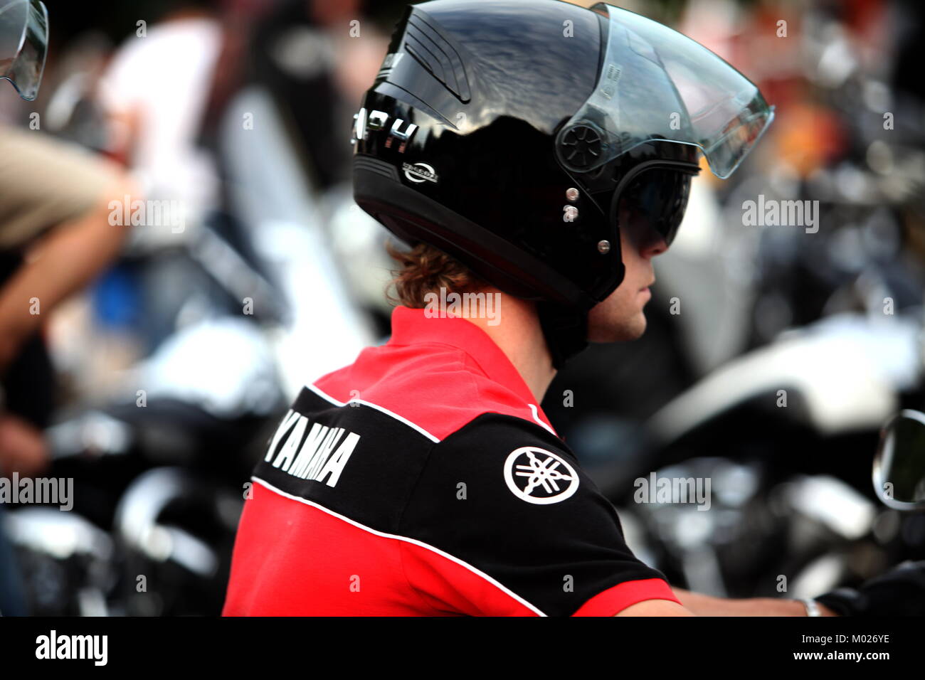 man on a motorcycle helmet in side view Stock Photo - Alamy