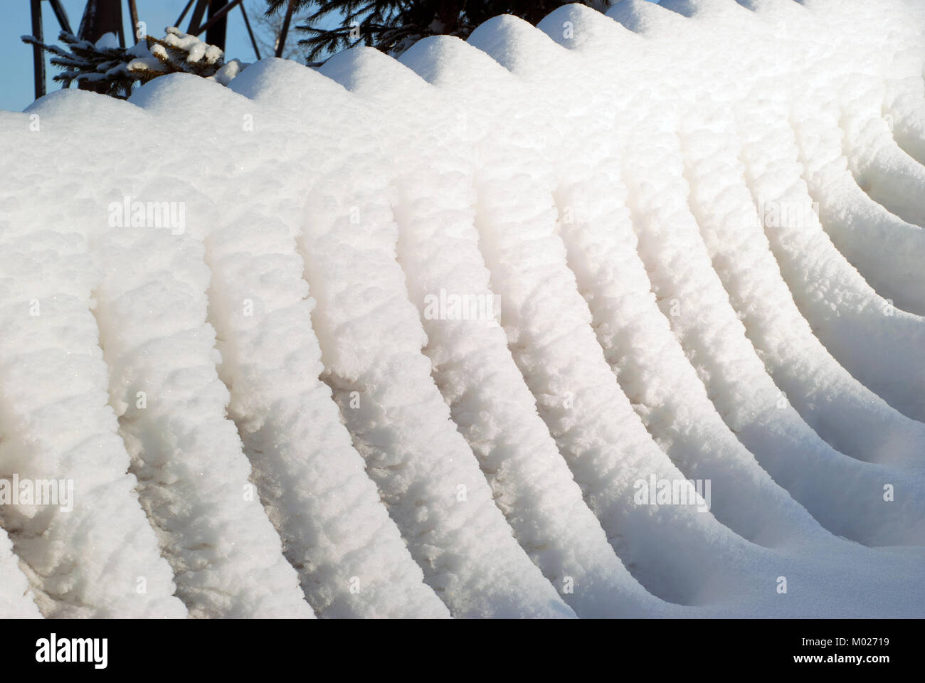 background: a simple boardwalk faded with snow, lit by the sun, closeup ...