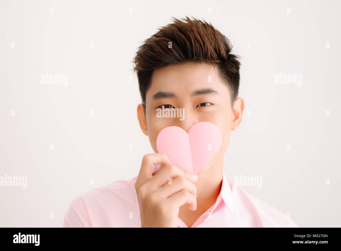 Handsome young asian man holding paper heart shaped valentine Stock ...