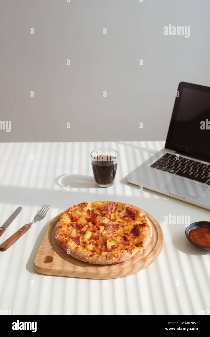Tasty pizza on office desk with coke and laptop, fast food Stock Photo ...