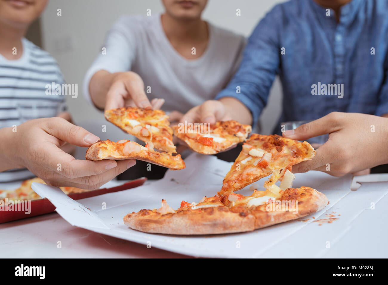 People eat fast food. Friends hands taking slices of pizza Stock Photo ...