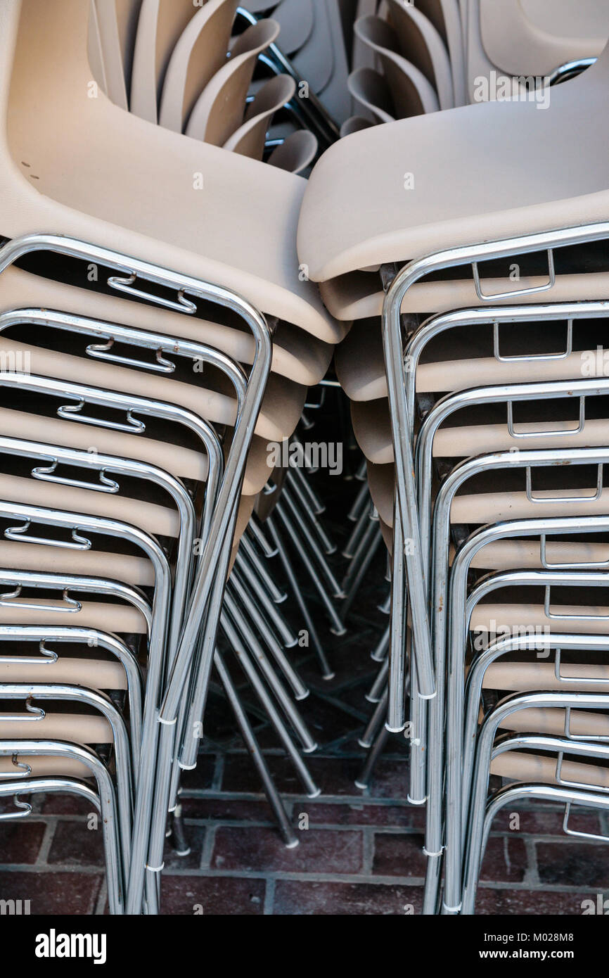 travel to France - many stacked plastic chairs in outdoor cafe in ...